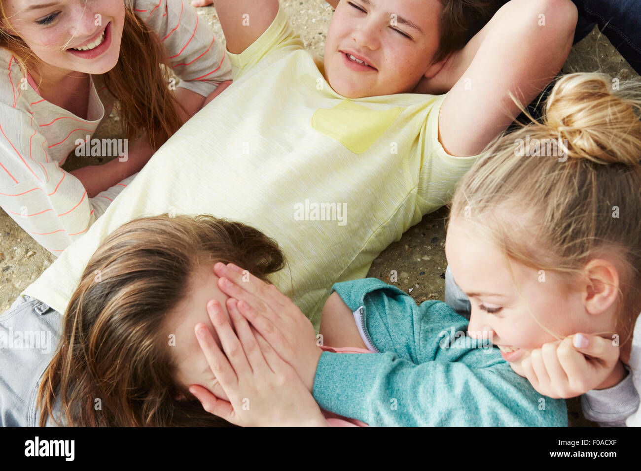 Cropped view of five boys and girls fooling around laughing Stock Photo ...