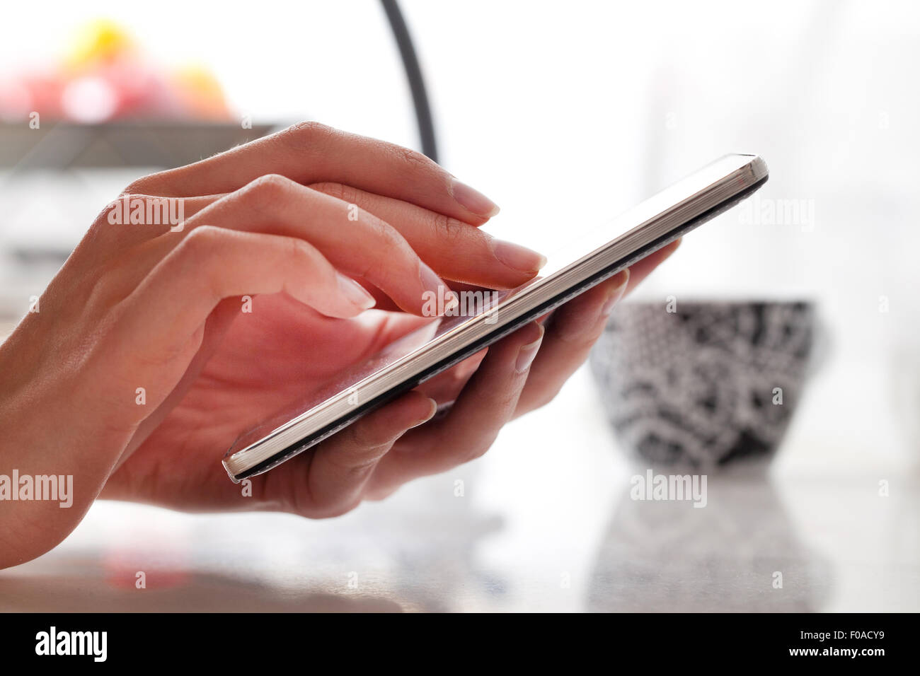 Hand holding smartphone device and touching screen Stock Photo - Alamy
