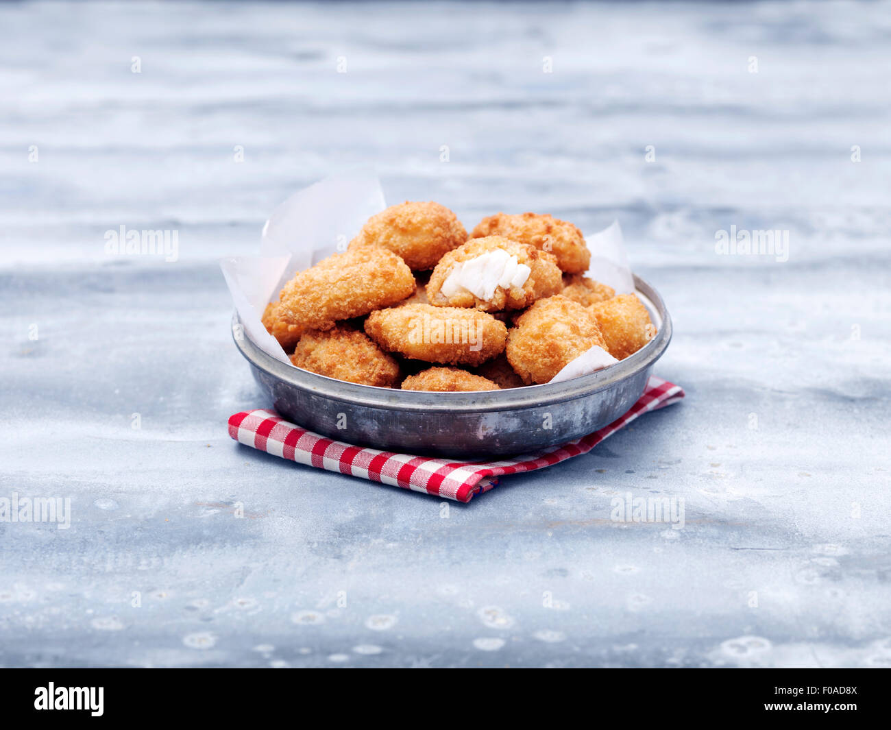Bowl of fried chunky cod breaded nuggets on steel table Stock Photo - Alamy