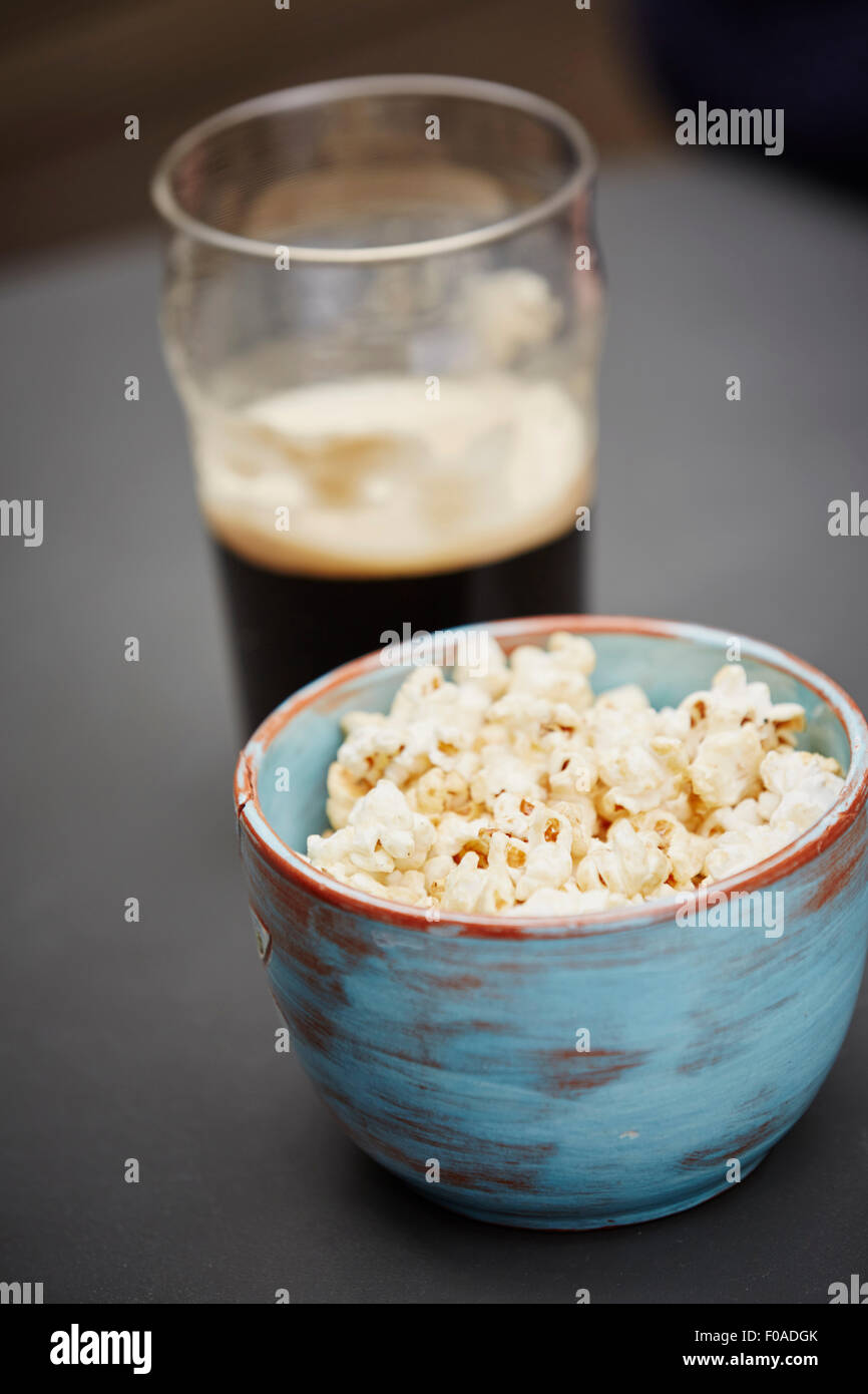 Bowl of popcorn and pint of beer Stock Photo - Alamy