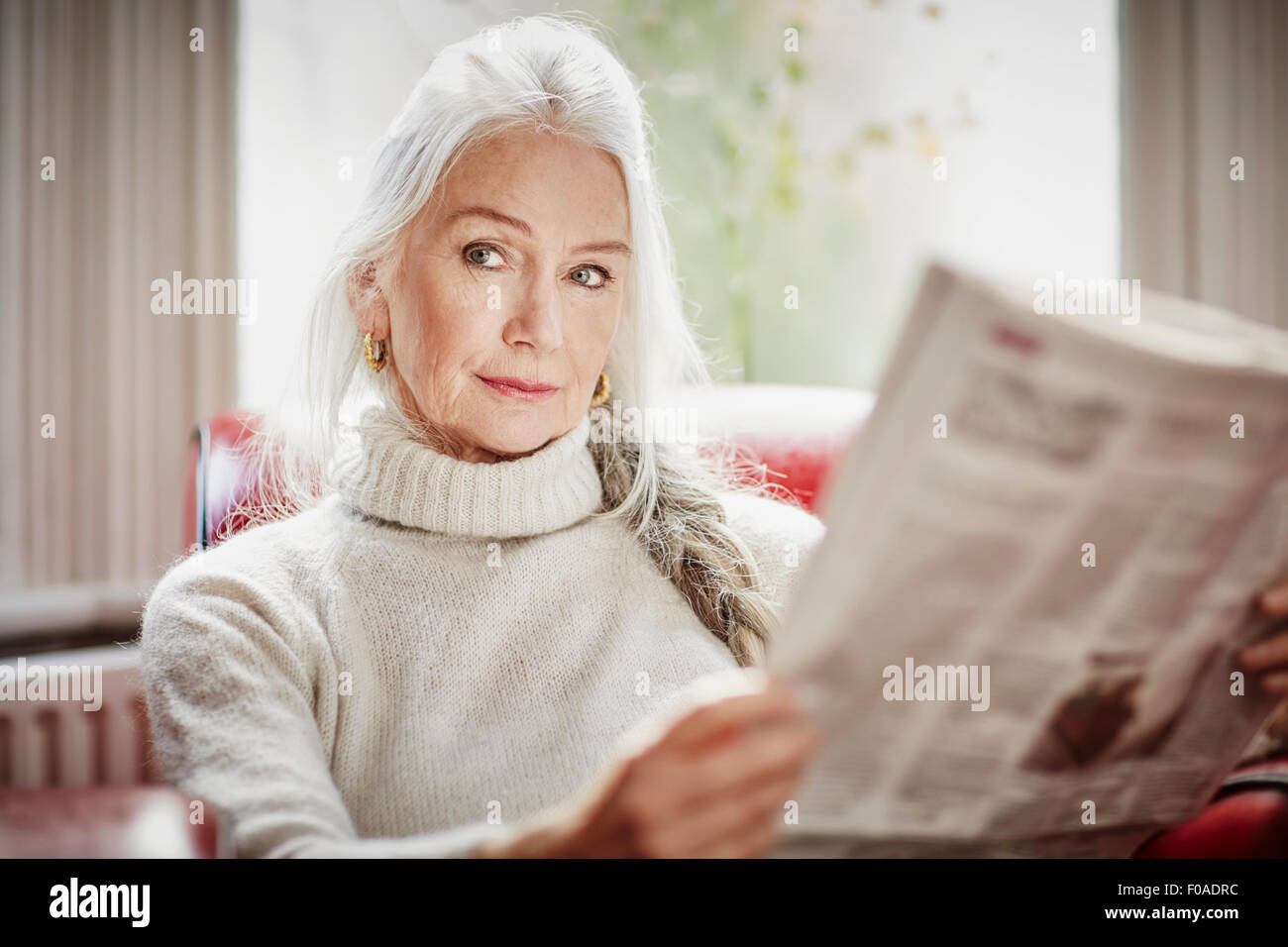 Senior woman reading newspaper Stock Photo - Alamy