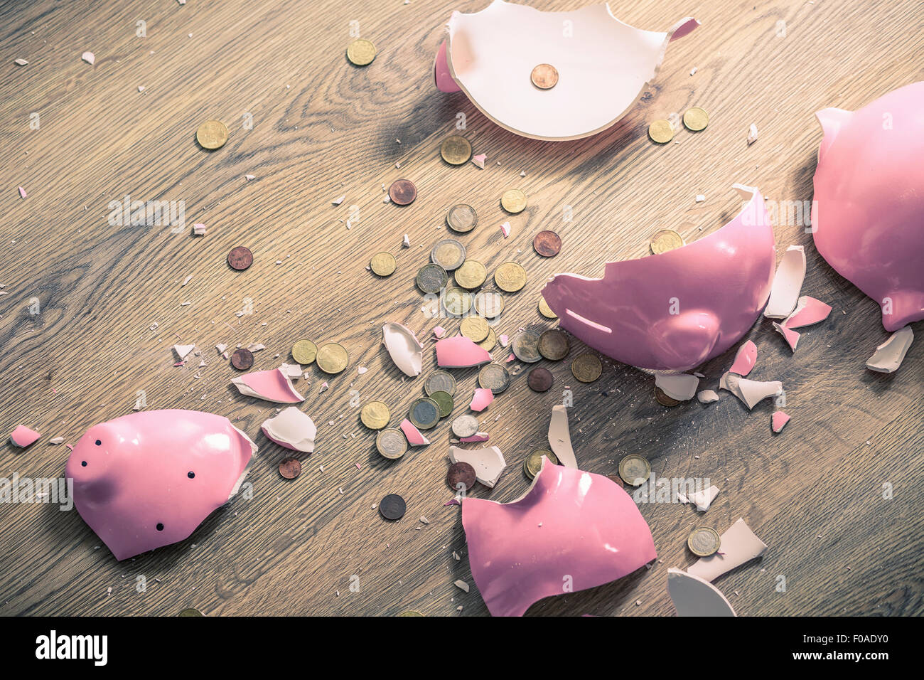 Broken piggy bank and coins Stock Photo - Alamy