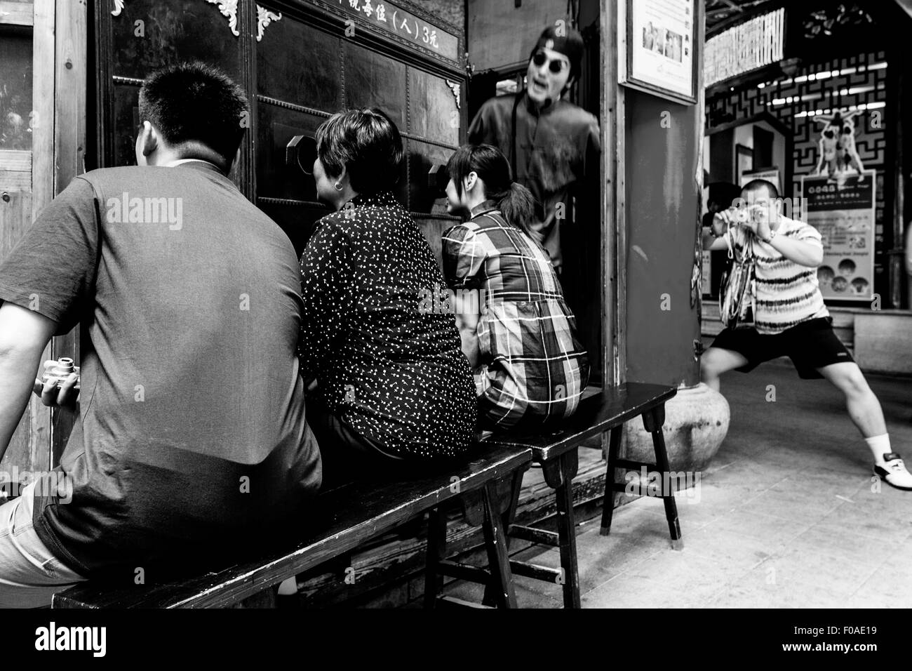 A Man Takes A Photograph Of People Watching A Traditional Chinese Peep ...