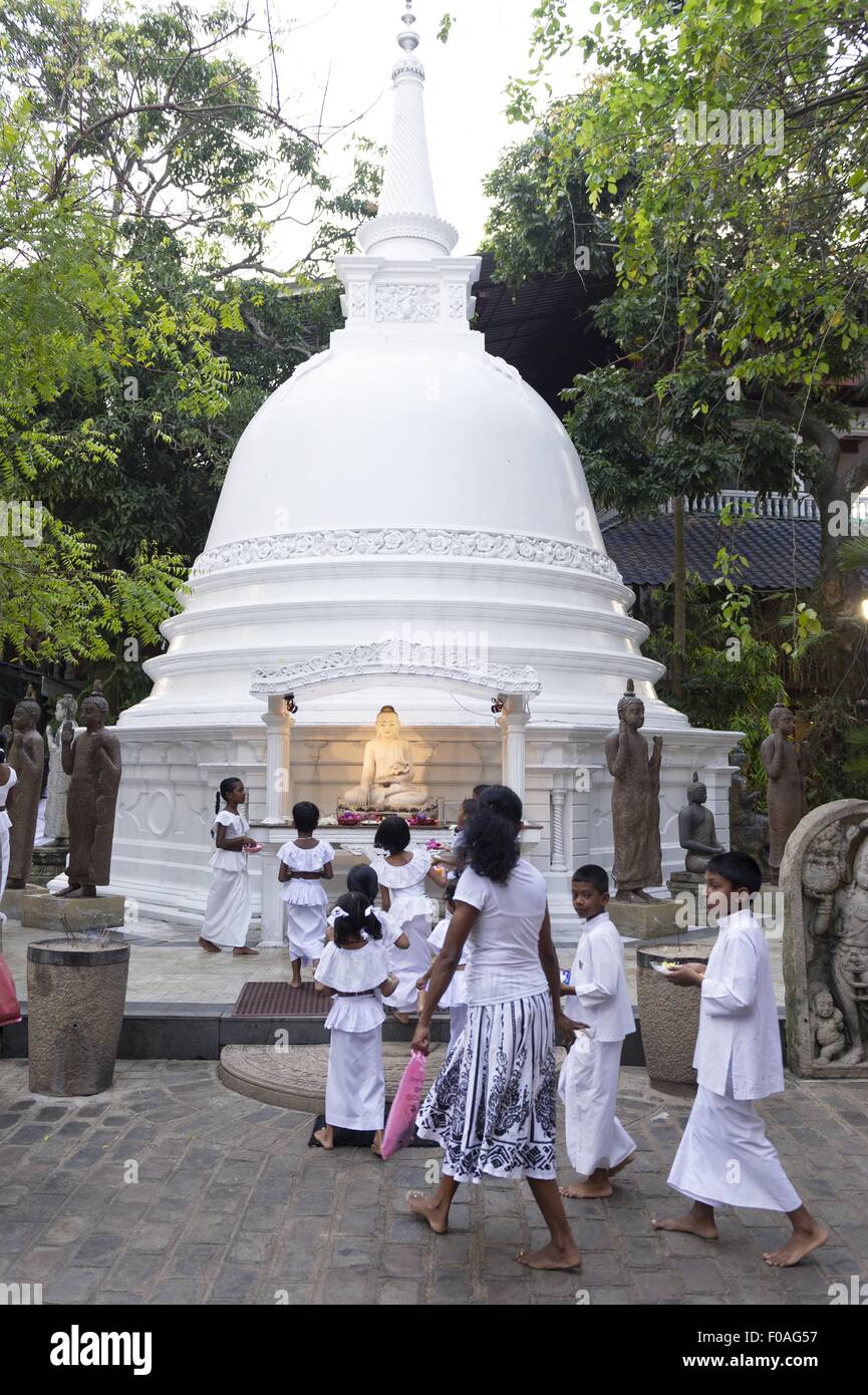 Children and woman at Gangaramya temple during Navam Perahera, Colombo ...