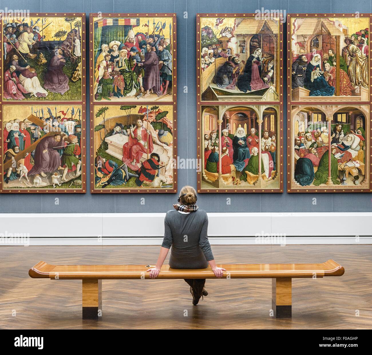 Woman sitting on bench and looking at pictures at Berlin State Museums ...