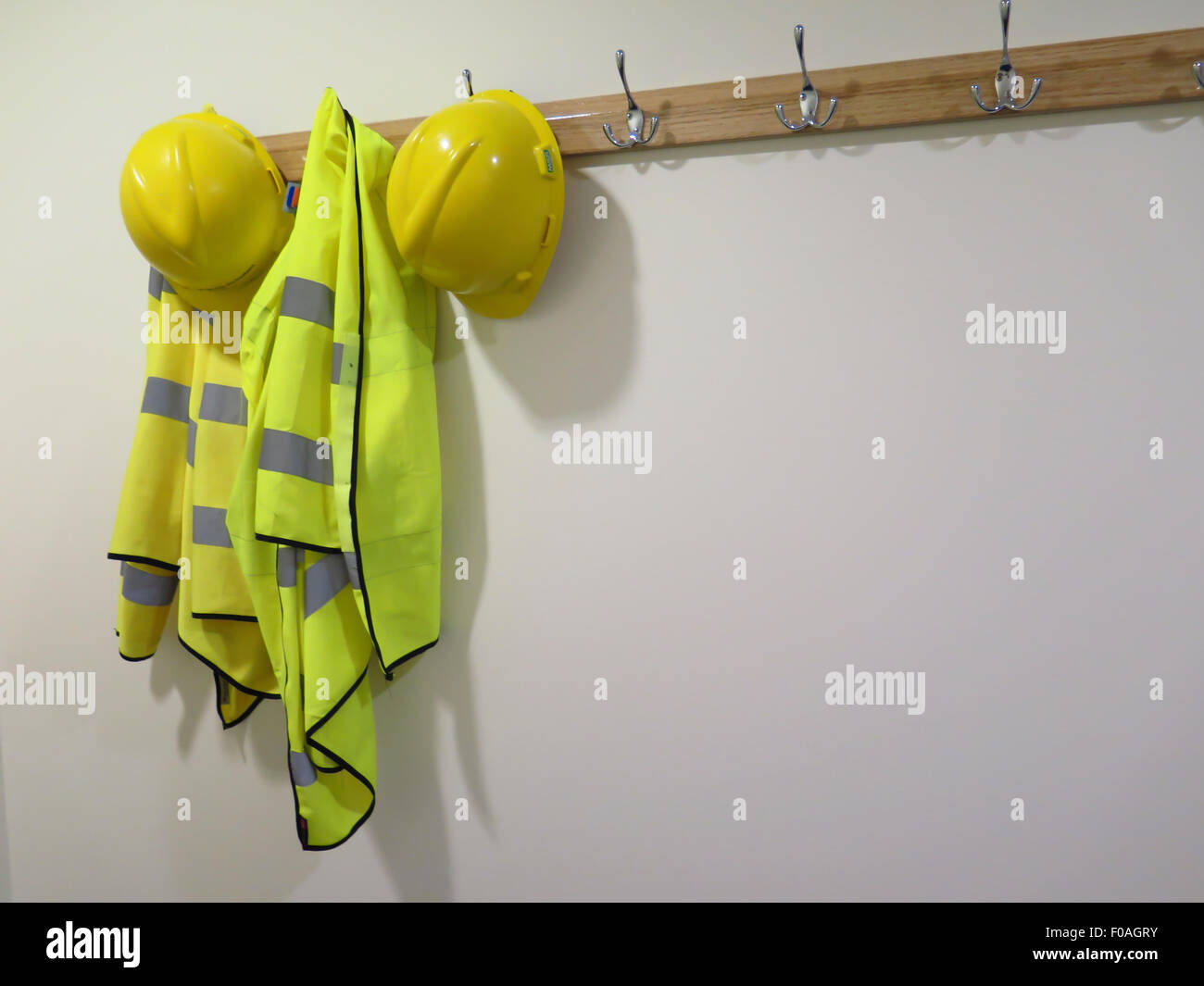 PPE clothing hanging on hooks Stock Photo - Alamy