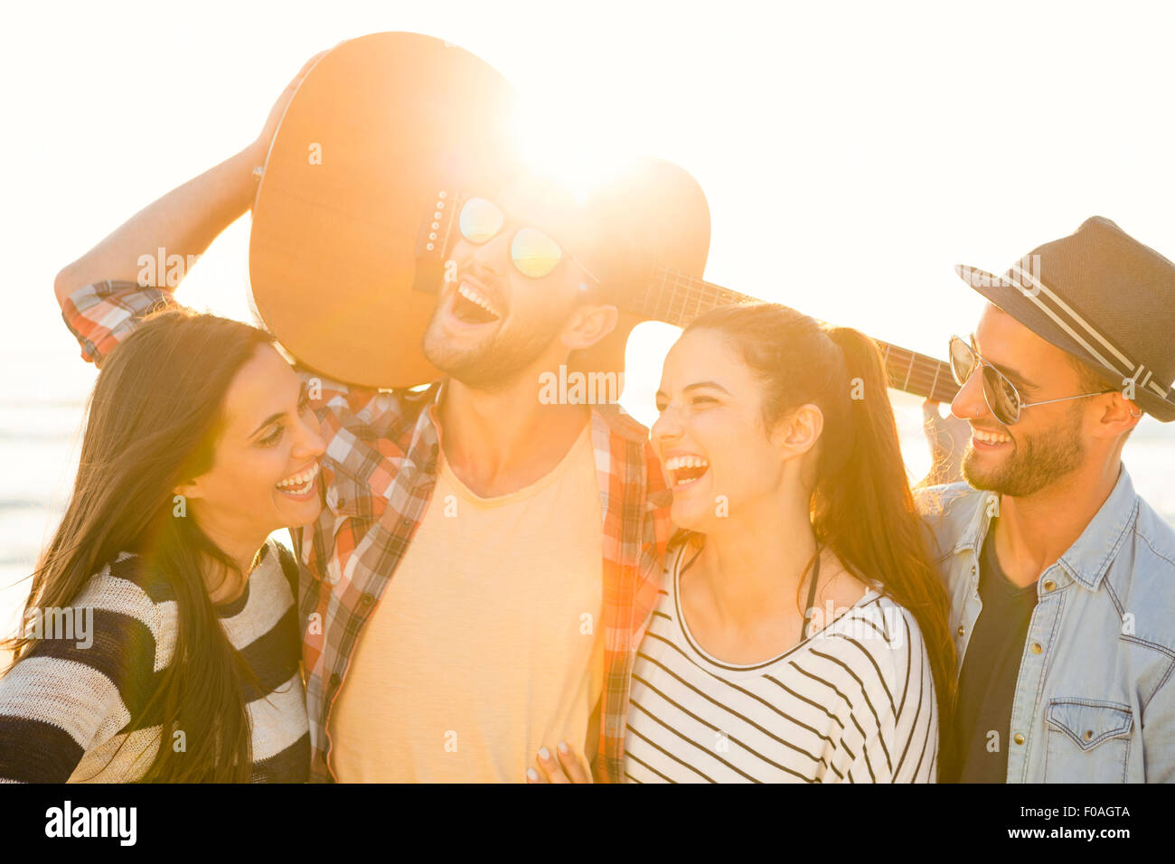 Friends at the beach having fun together Stock Photo - Alamy