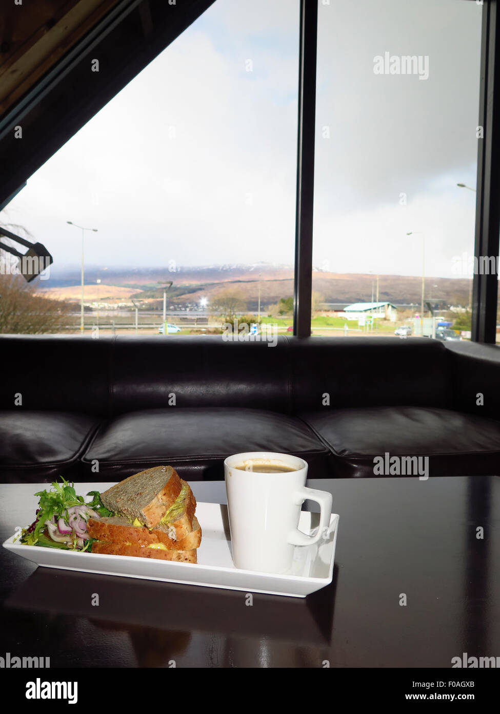 Coffee and sandwich on café table plate Stock Photo - Alamy