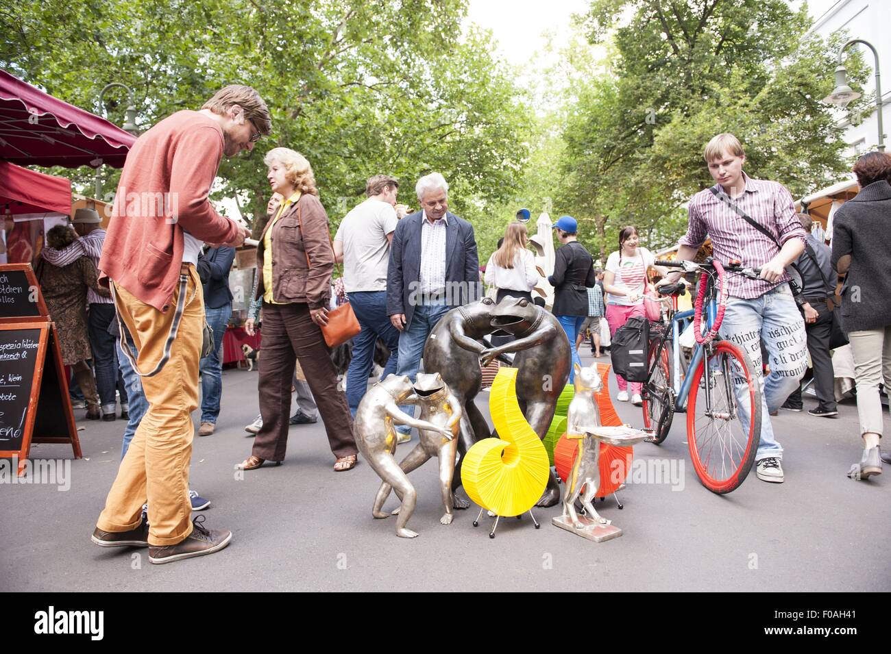 Various figures on middle of market street in Prenzlauer Berg, Berlin ...