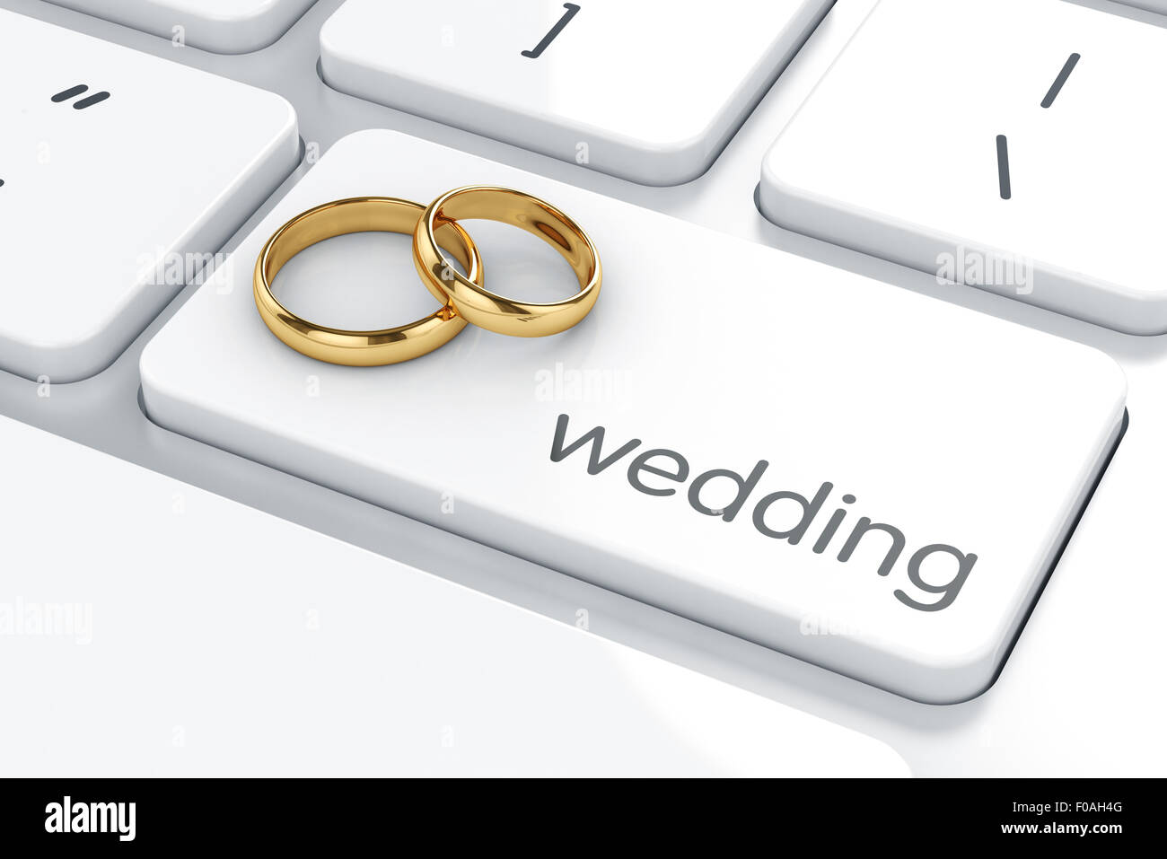 Golden rings on the computer keyboard. Wedding concept Stock Photo - Alamy
