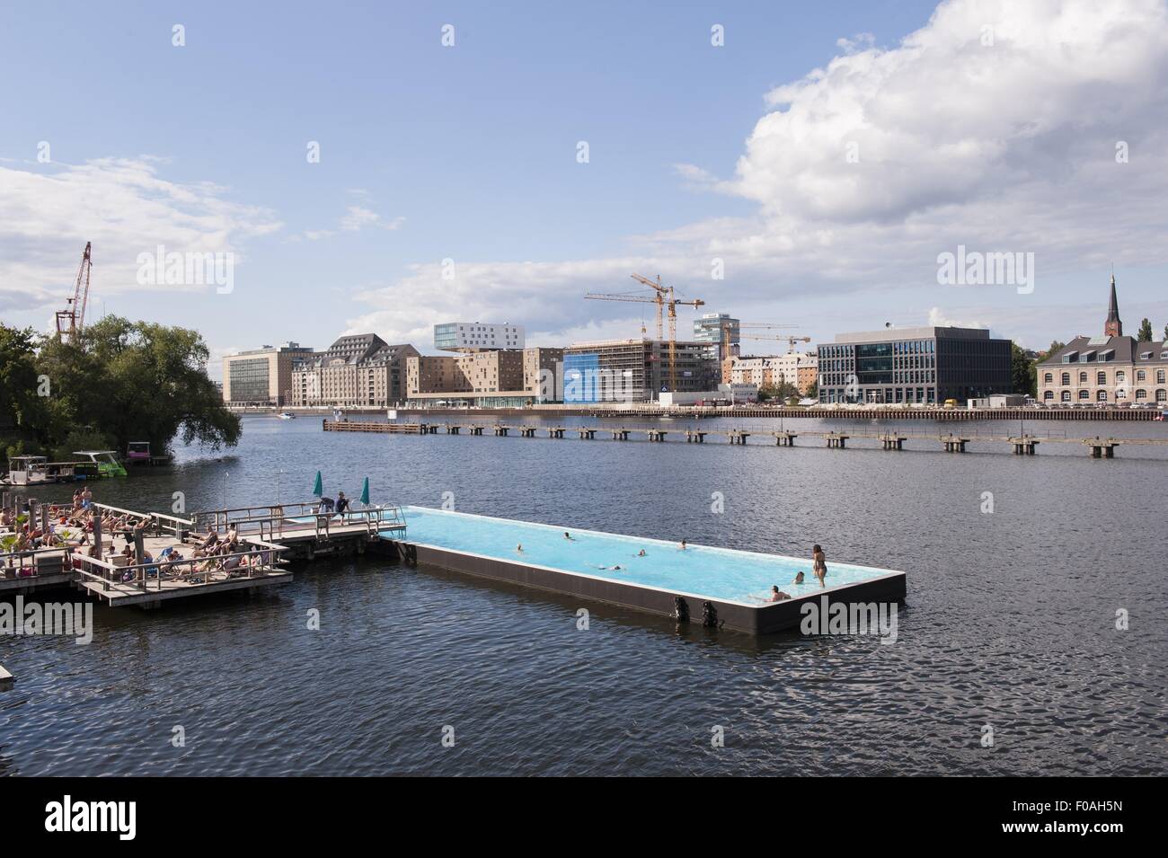 People enjoying at bathing ship pool on Spree river at Wrangelkiez ...