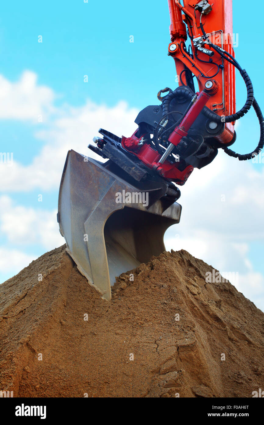 Red coloured construction digger Stock Photo - Alamy