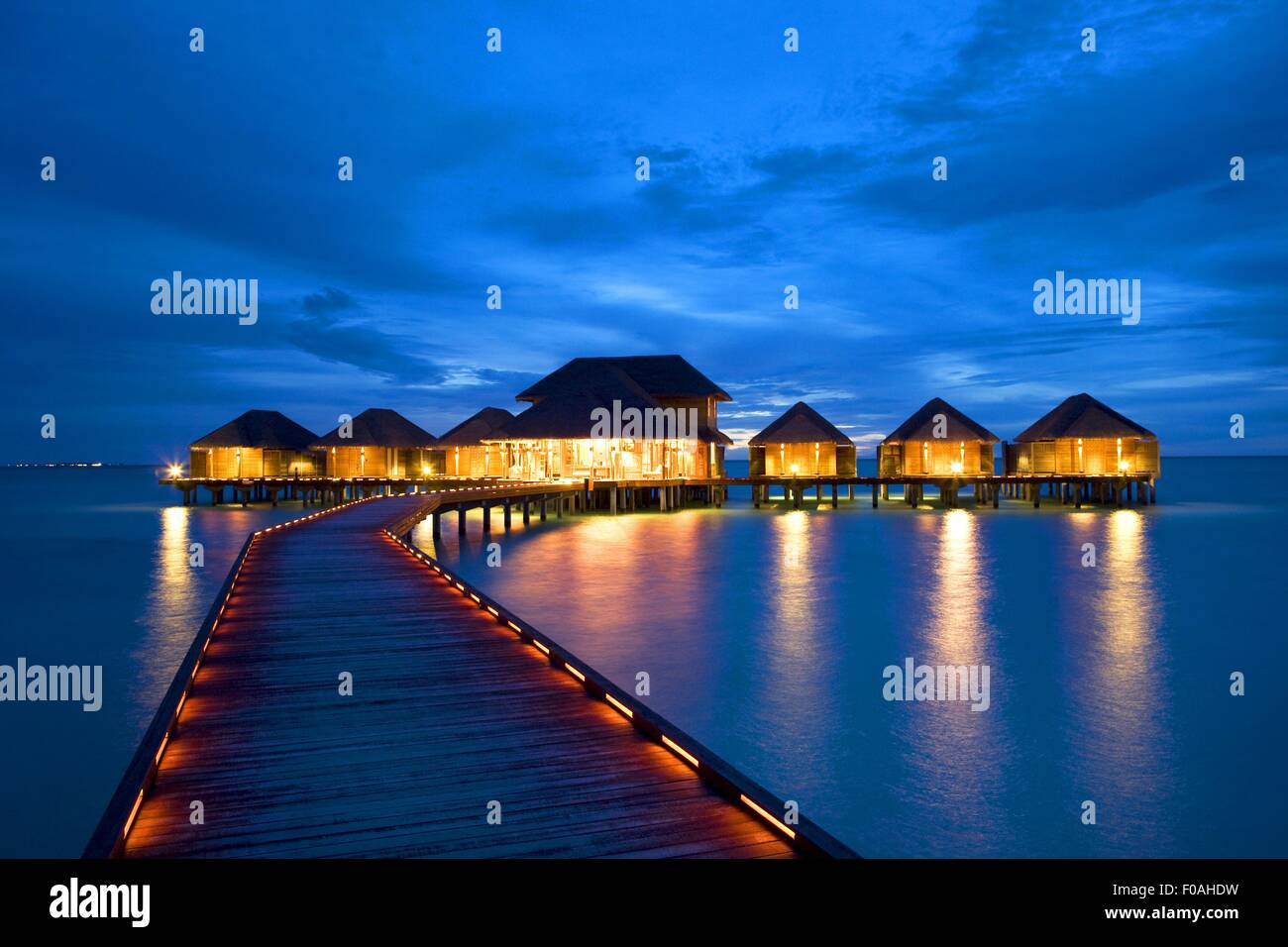 Illuminated dock huts on Dhigufinolhu island, Maldives Stock Photo - Alamy
