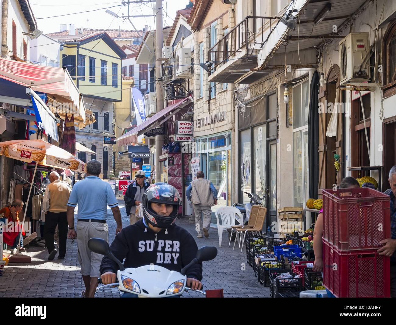 People at street with buildings on side in Cesme, Turkey Stock Photo ...