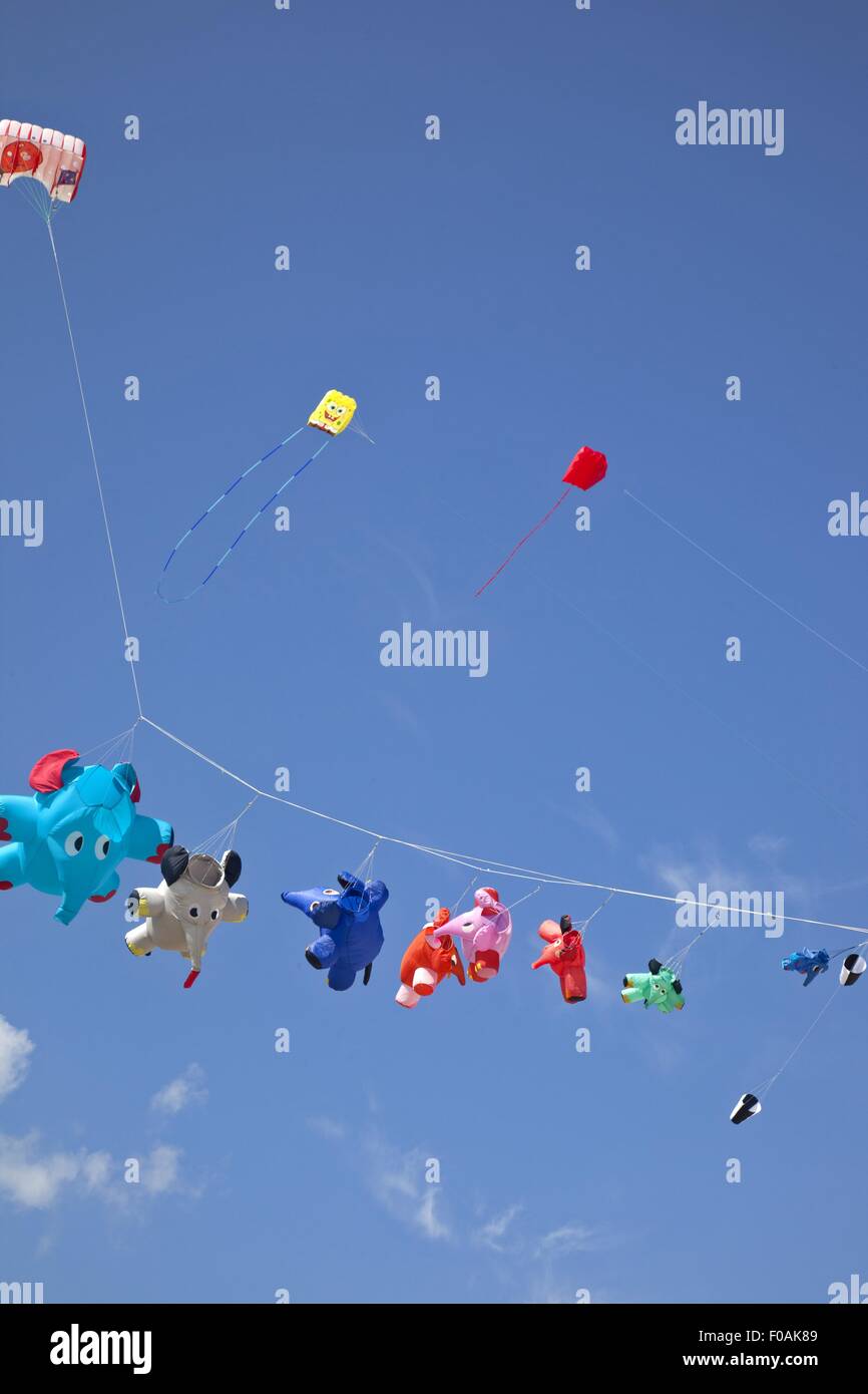 Multi-coloured flags in sky on kite festival at Fano beach, Denmark ...