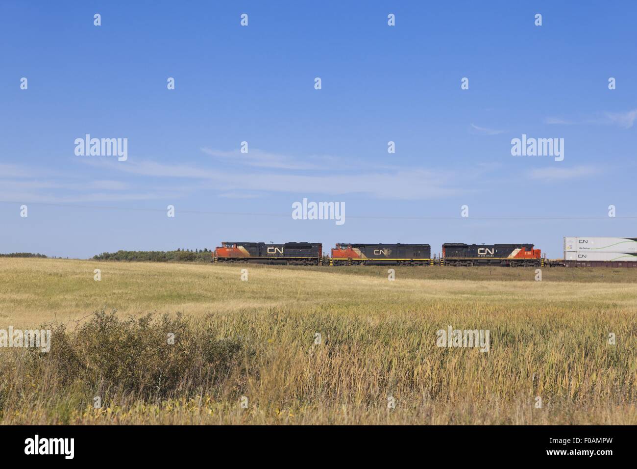 View of train and landscape along Highway 15, Saskatchewan, Canada ...
