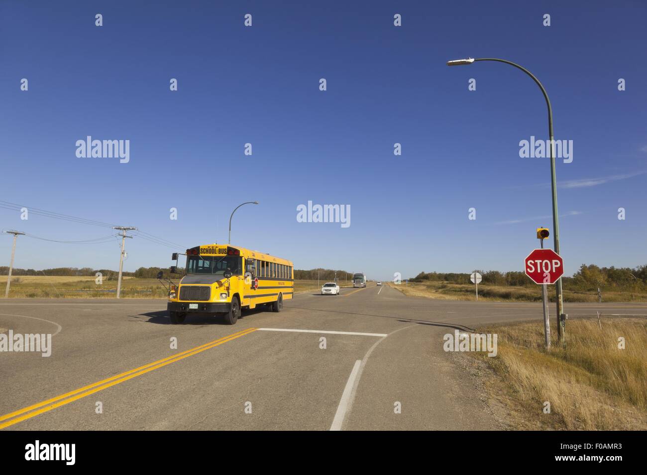 School bus crossing Highway 15 and 35, Saskatchewan, Canada Stock Photo ...