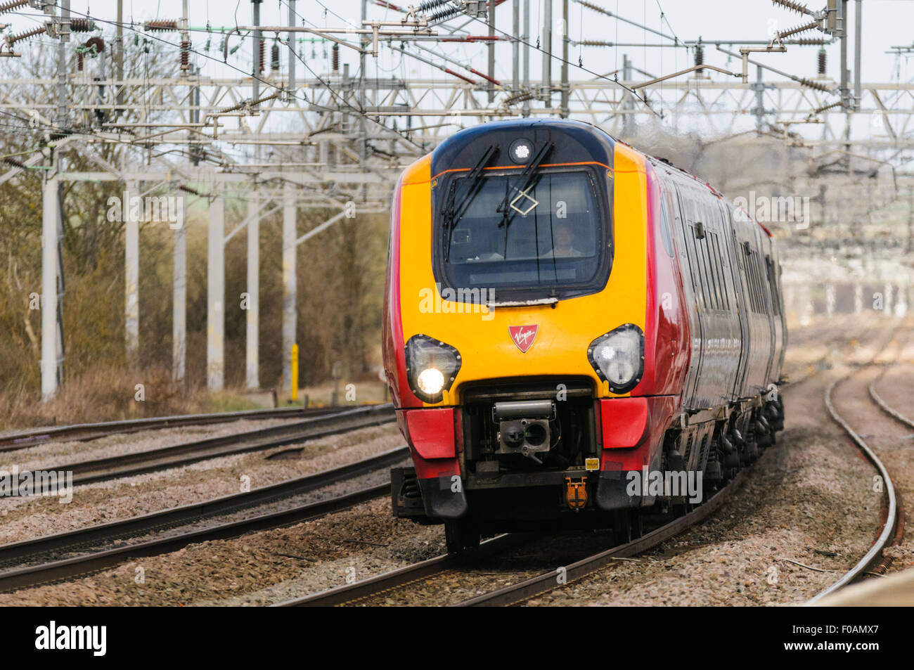 Virgin Trains Voyager train passing through Rugeley railway station on ...