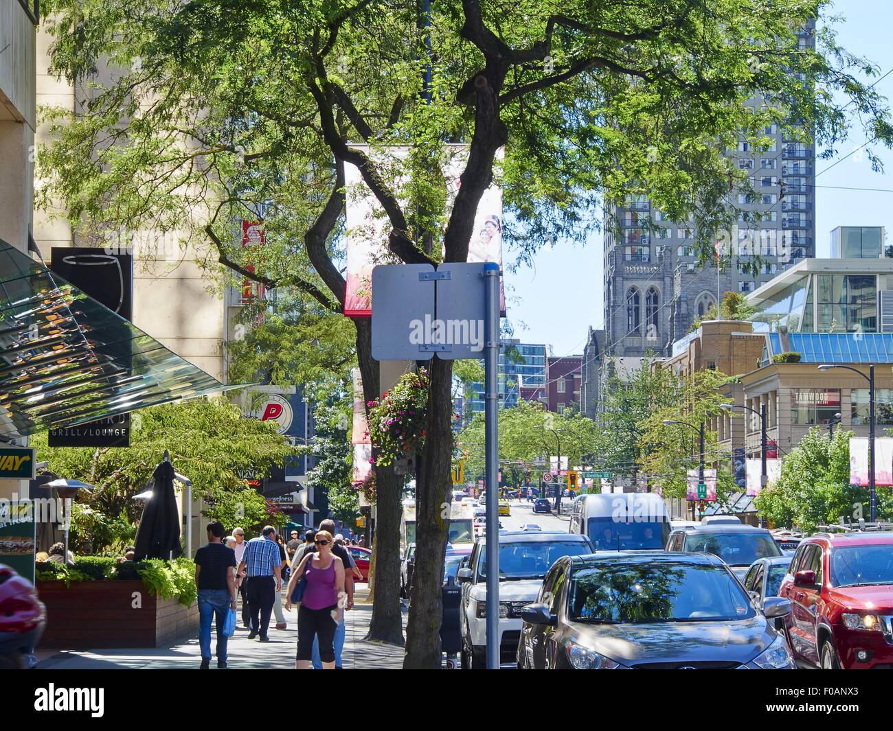 People walking and cars on street in Vancouver City in British Columbia ...