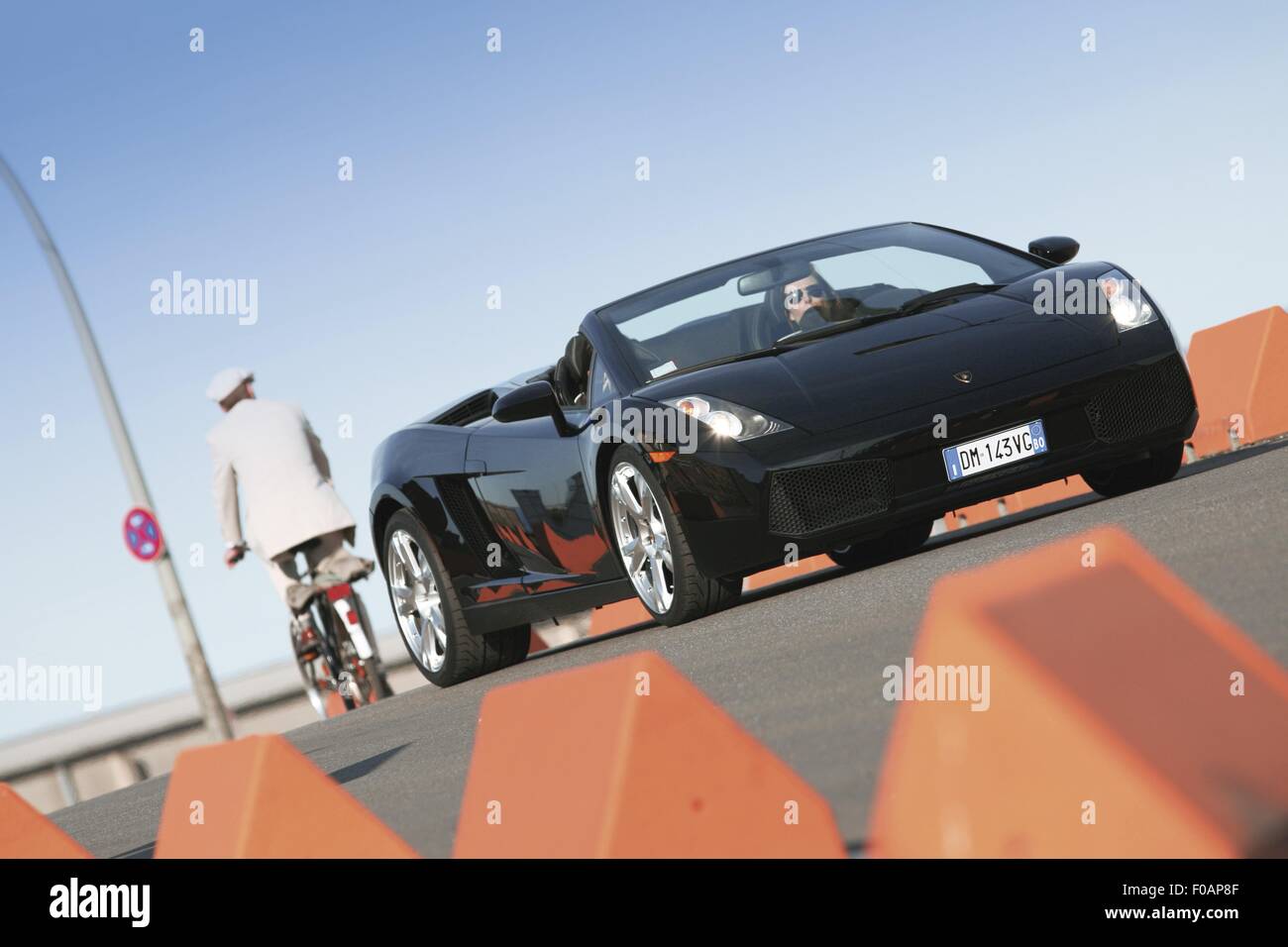 Woman driving a black convertible car on road Stock Photo - Alamy