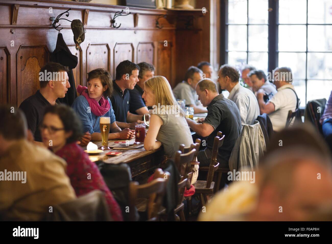 People sitting and enjoying in bar Stock Photo - Alamy