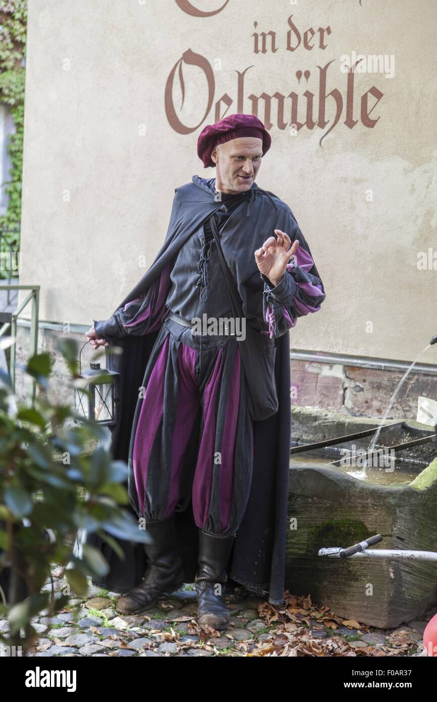 Medieval city leader standing against wall written with Oelmuhle in ...