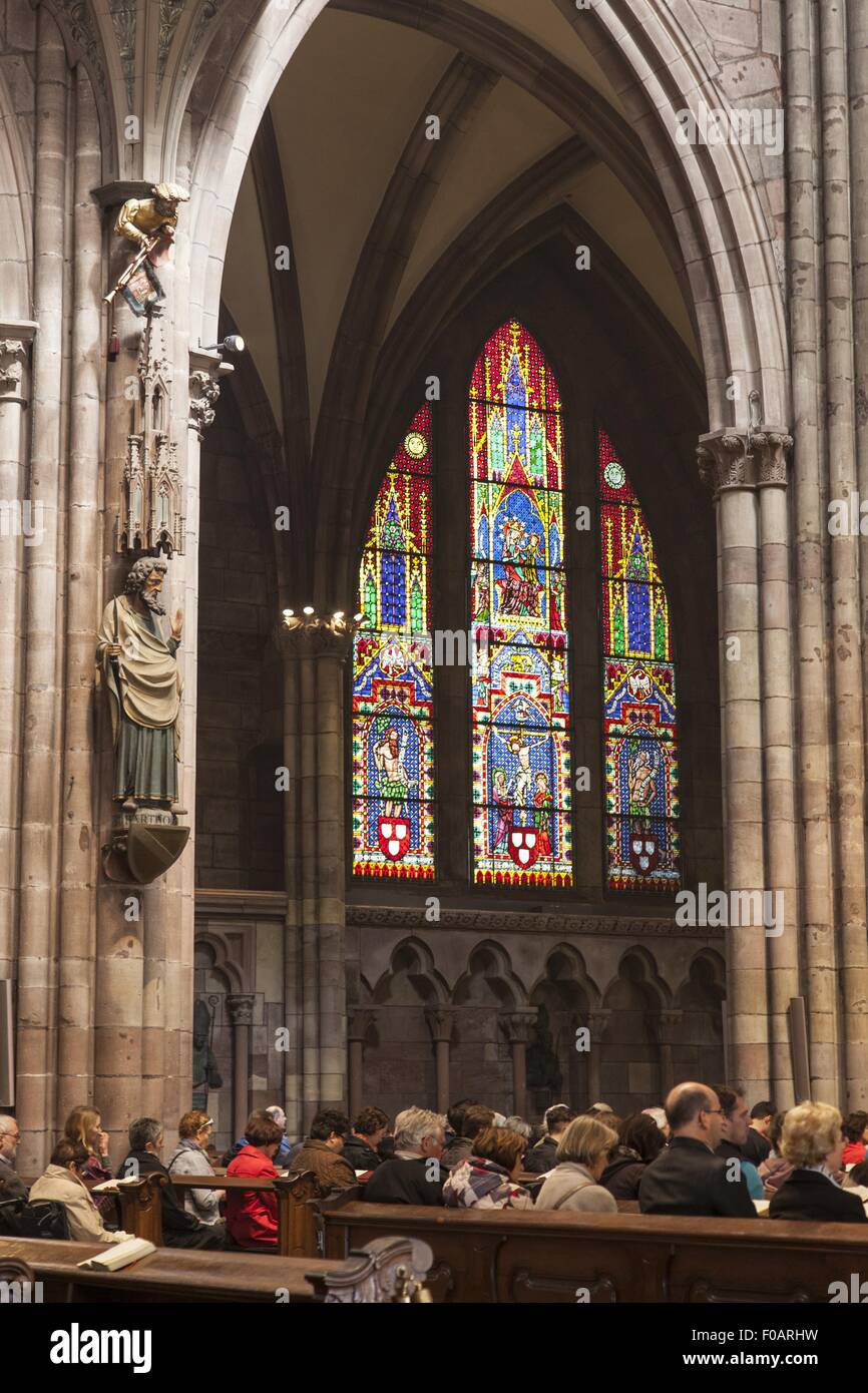 People sitting and praying in Munster, Freiburg, Germany Stock Photo ...