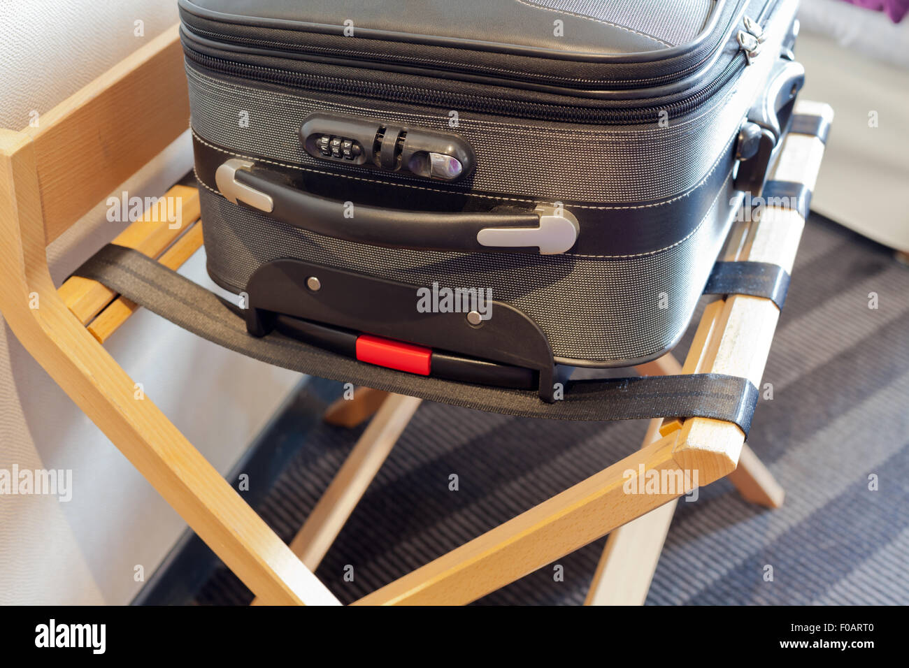 Hotel room with a suitcase on the luggage place Stock Photo - Alamy