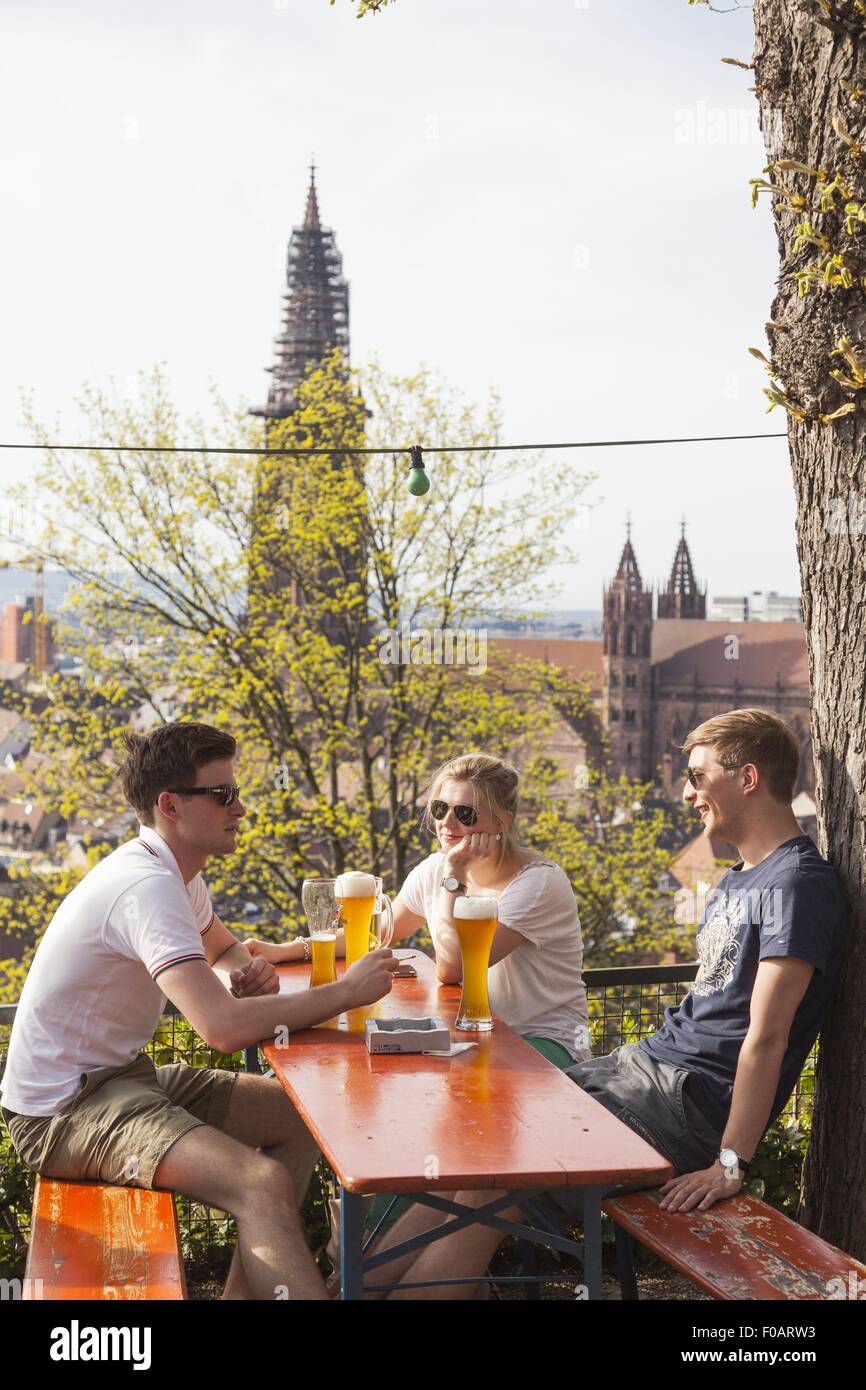 People enjoying beer in beer garden on the castle hill, Freiburg ...