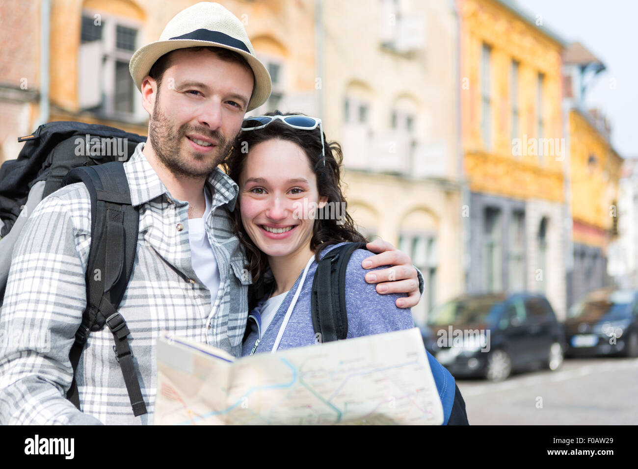 View of a Couple of young attractive tourists watching map Stock Photo ...