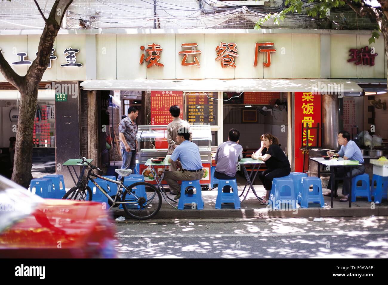 People sitting in front of Aisa Snack at French Concession district ...