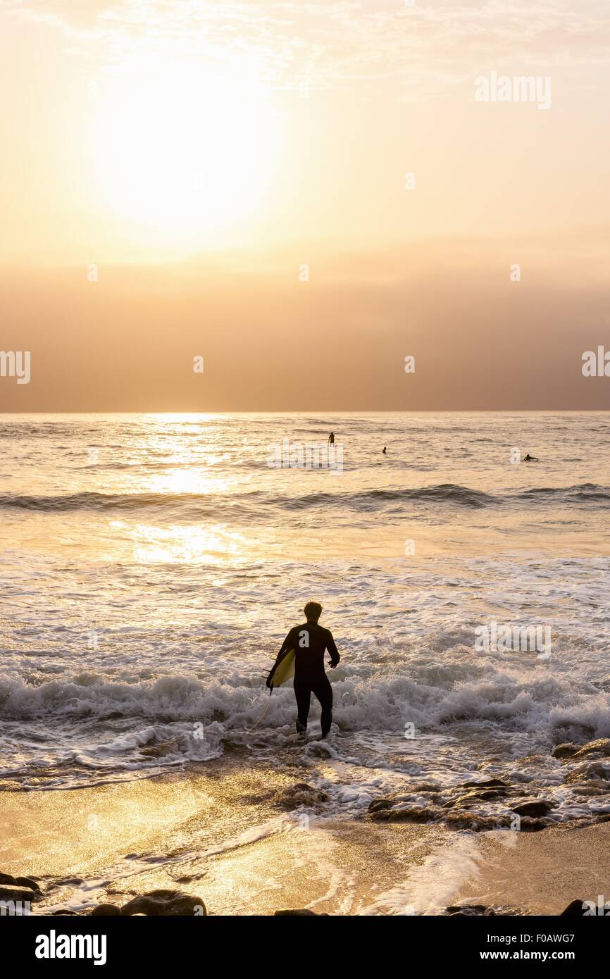 A surfer on the beach in Swakopmund, Namibia at sunset Stock Photo - Alamy