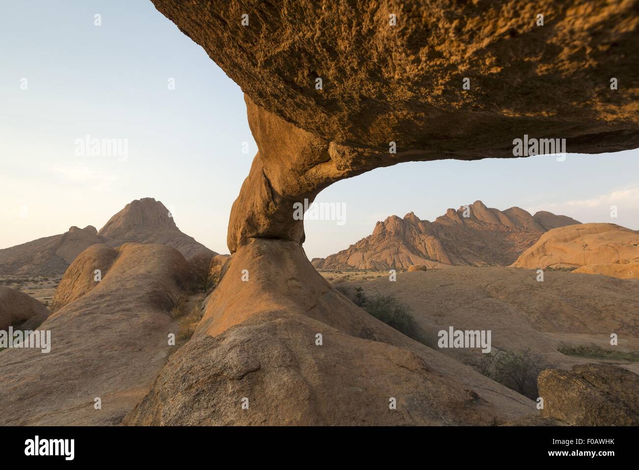 'Rock Arch' in the Spitzkoppe region with a view of the Pondok mountains, Erongo mountain range ...