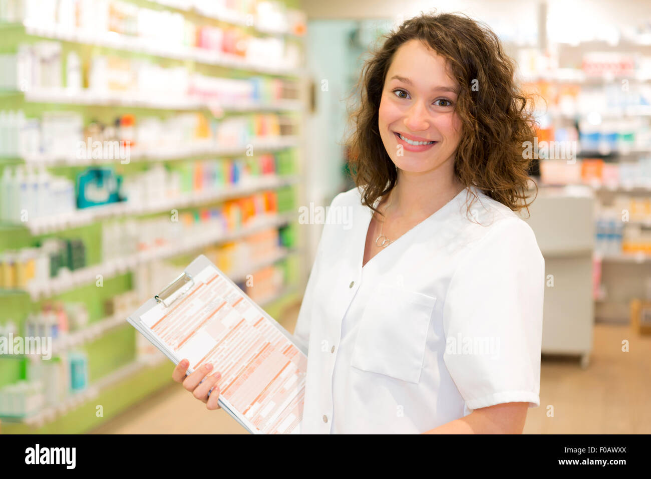 View of an Attractive pharmacist taking notes at work Stock Photo - Alamy