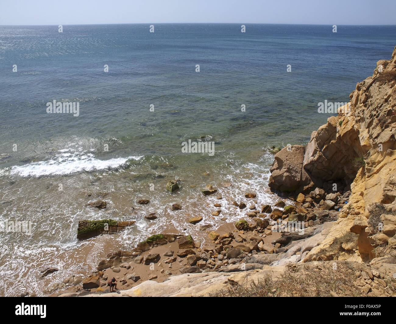 View of the rocky Paradise Beach in Asilah, Morocco Stock Photo - Alamy