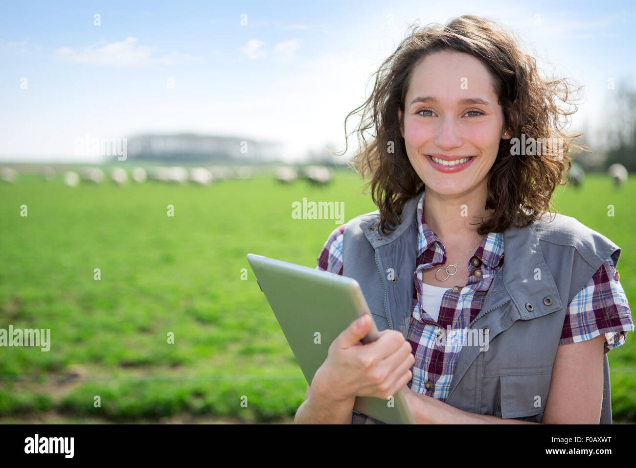 View of a Young attractive farmer in a field using tablet Stock Photo ...