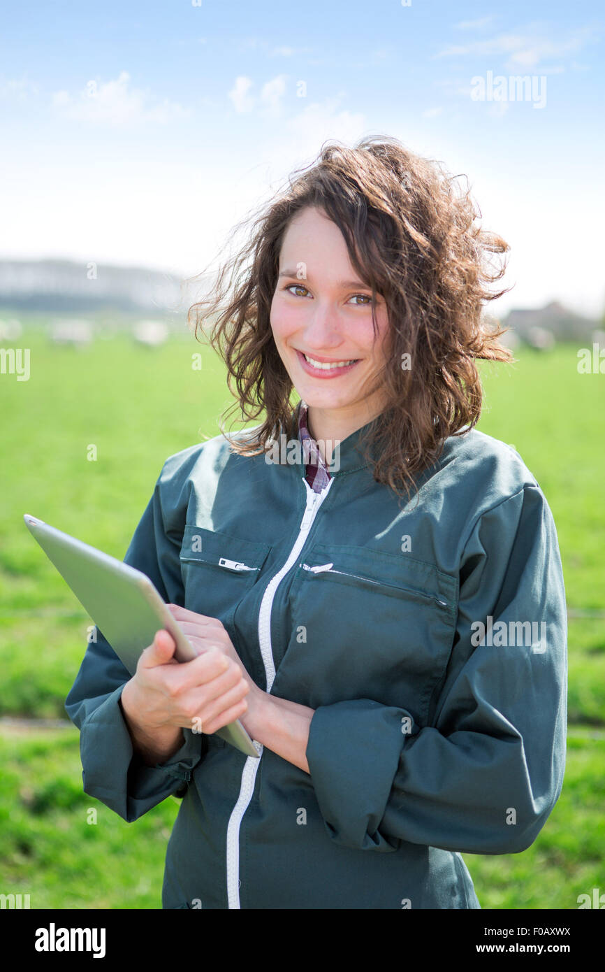 View of a Young attractive farmer in a field using tablet Stock Photo ...