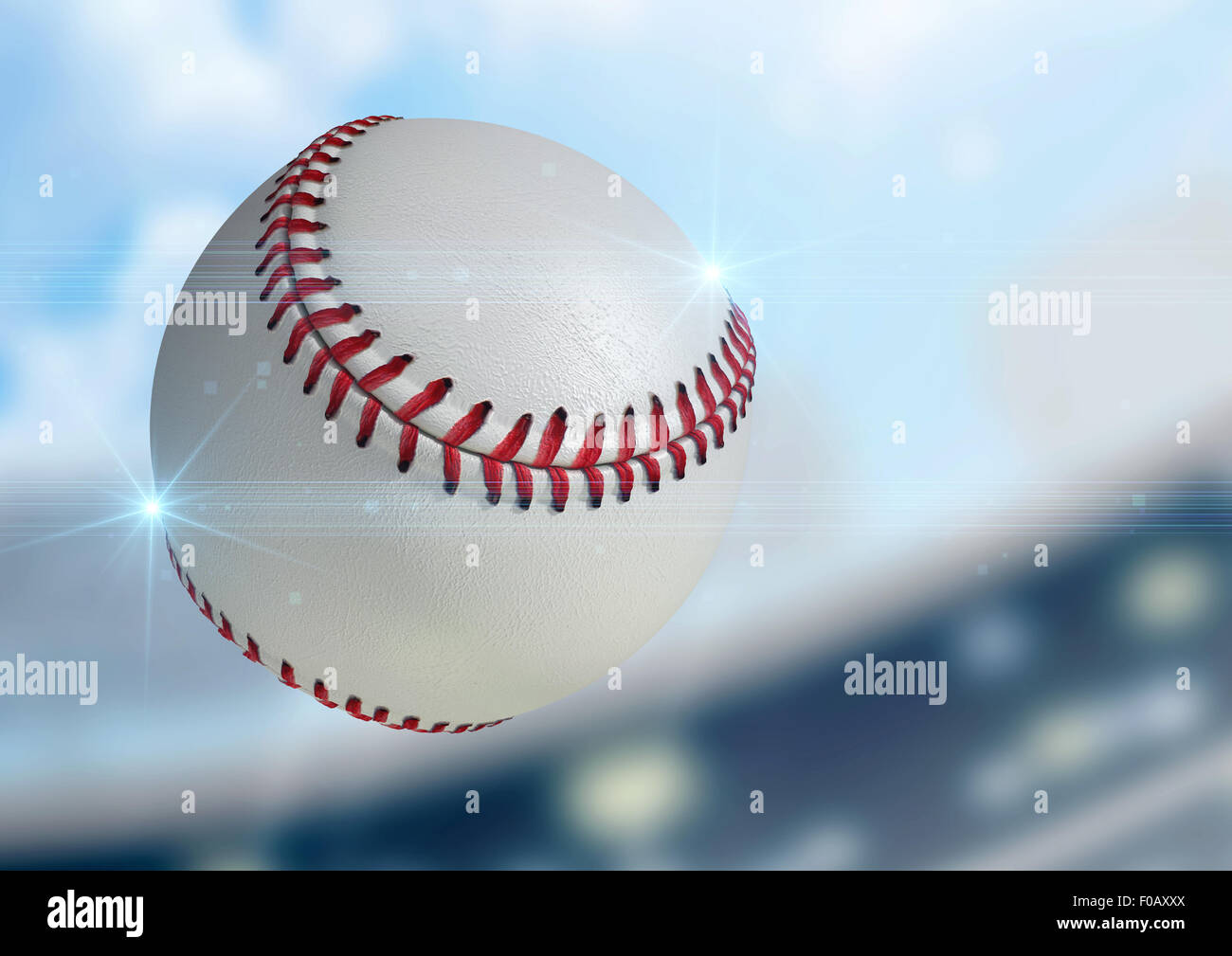 A regular baseball ball flying through the air on a stadium background ...