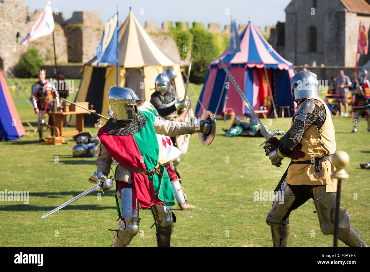 Performers in heavy armour fight at Portchester Castle in Hampshire ...