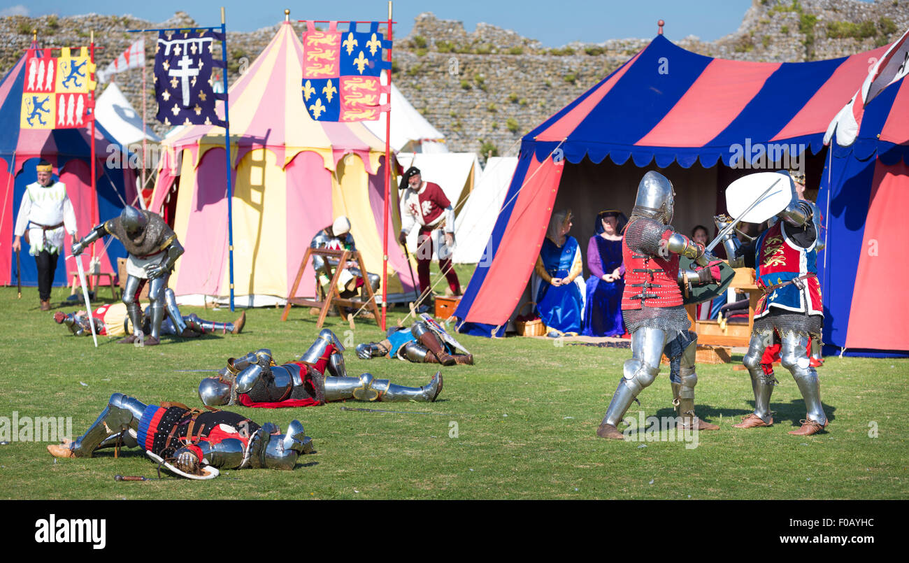 Performers in heavy armour fight at Portchester Castle in Hampshire ...