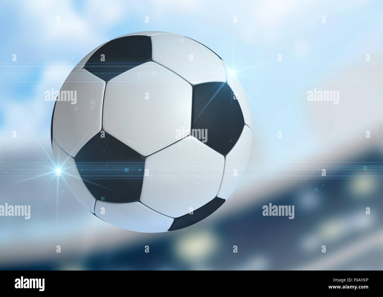 A regular soccer ball flying through the air on a stadium background ...