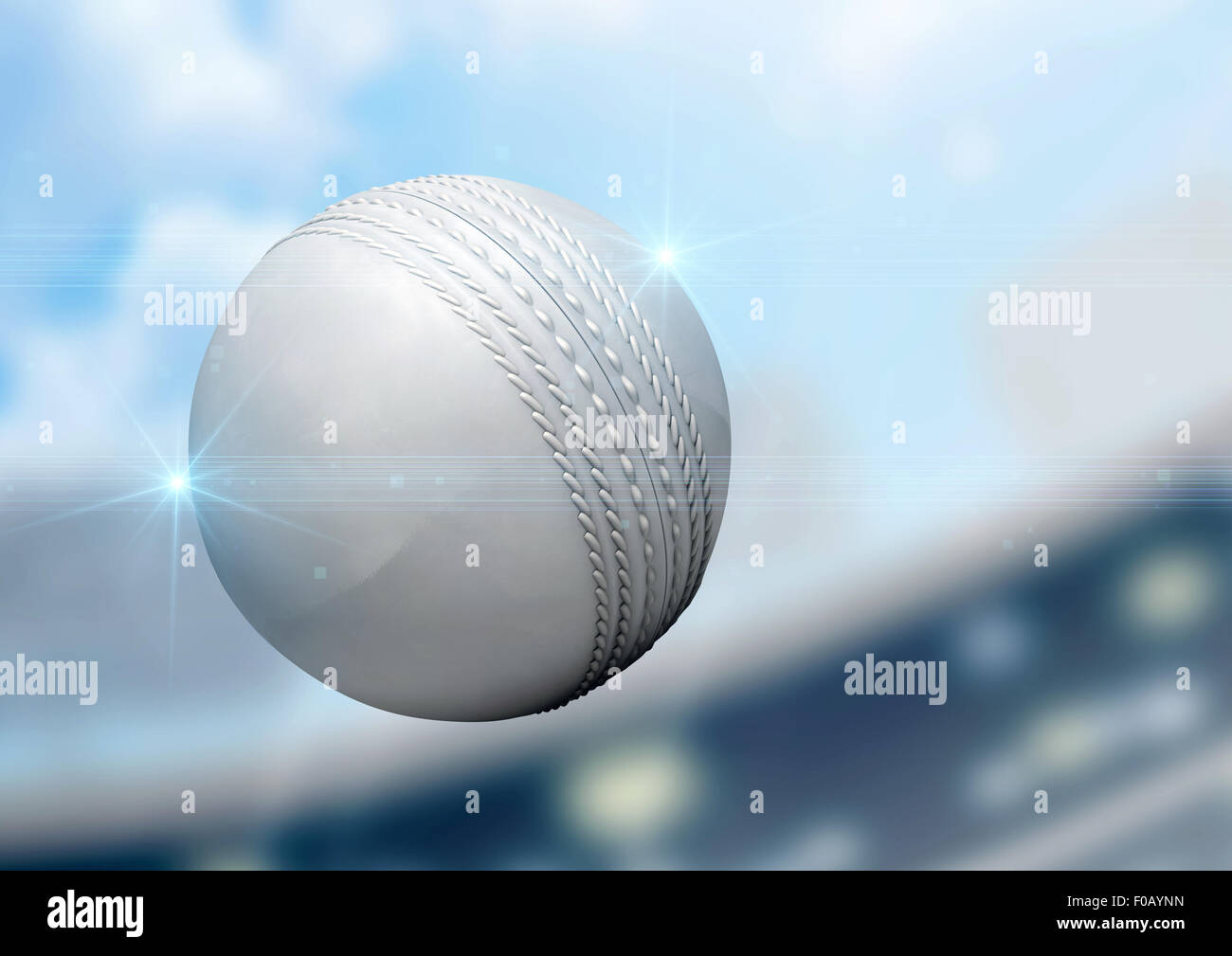 A regular white cricket ball flying through the air on a stadium ...