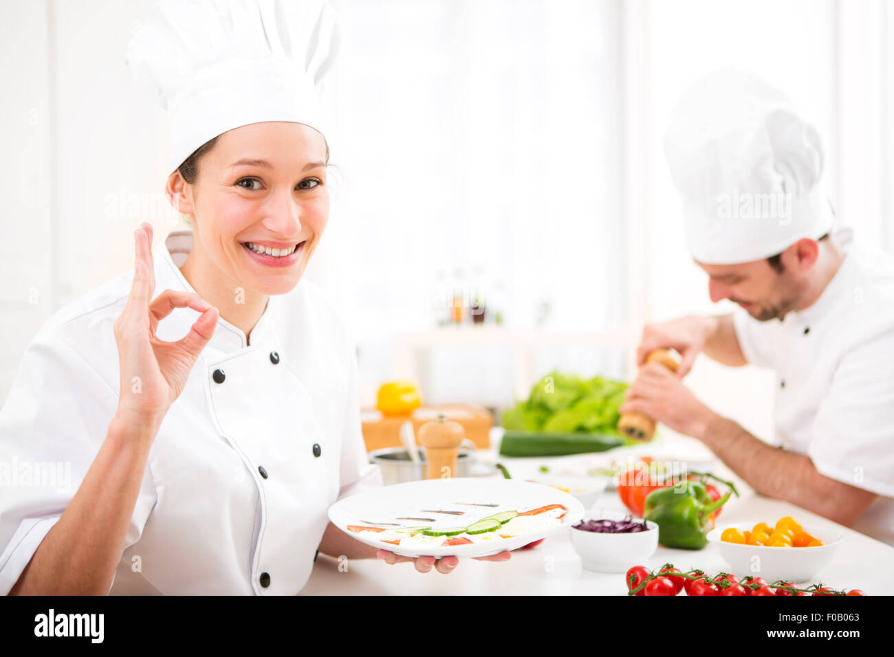 View of a Young attractive professional chef cooking in his kitchen ...