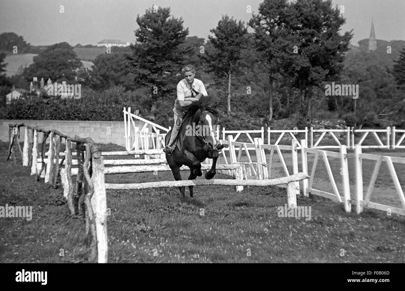 A teenage girl practicing showjumping Stock Photo - Alamy