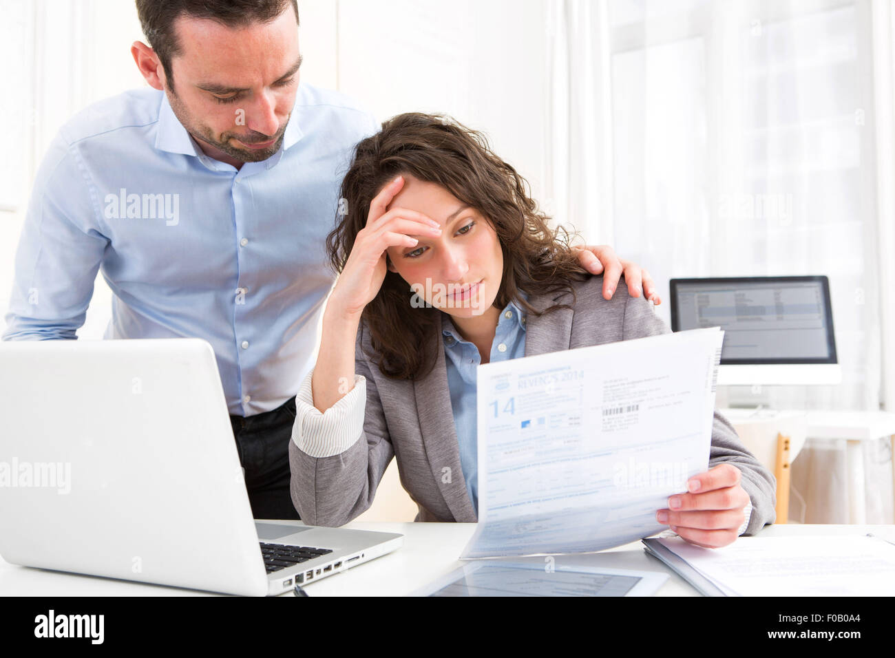 View of a Young attractive couple doing paperwork Stock Photo - Alamy