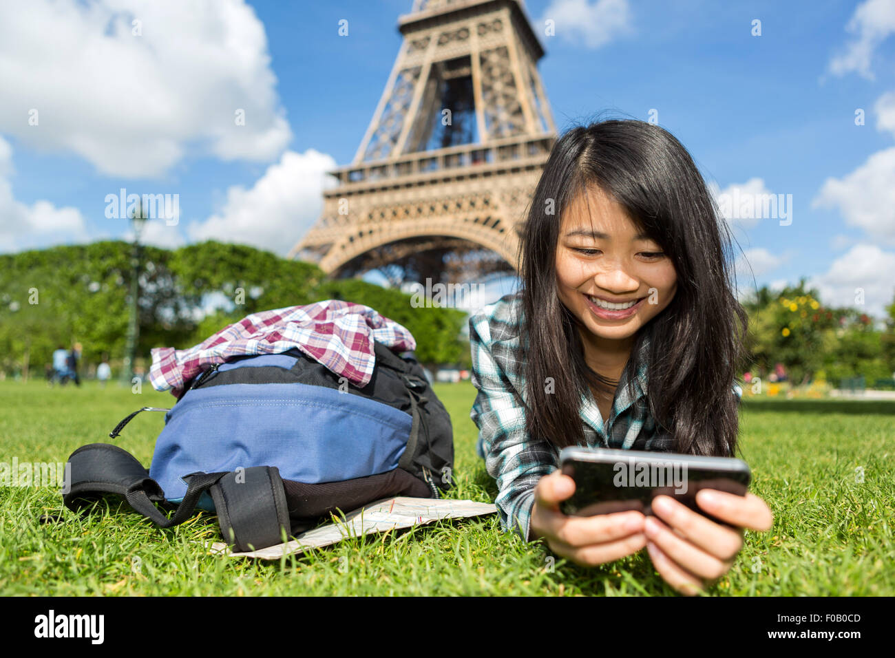 View of a Young attractive asian tourist smartphone tablet in Paris ...