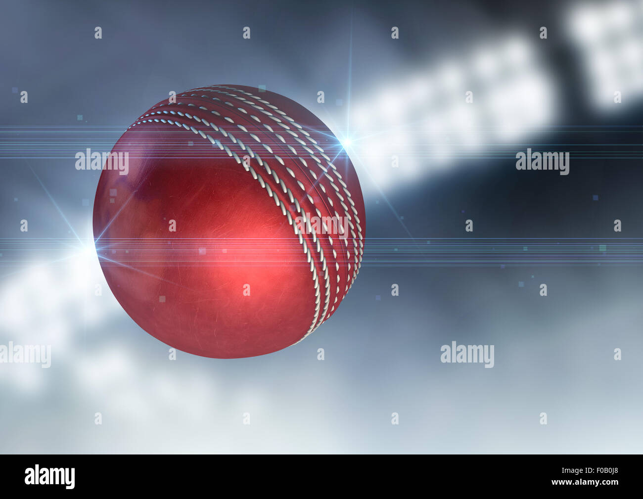A regular red cricket ball flying through the air on an indoor stadium ...
