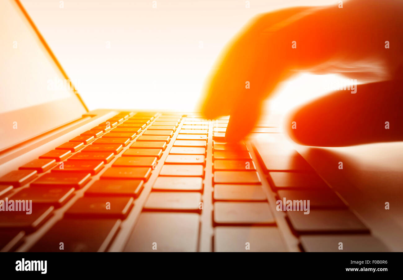 Close up of a hand typing on laptop keyboard Stock Photo - Alamy
