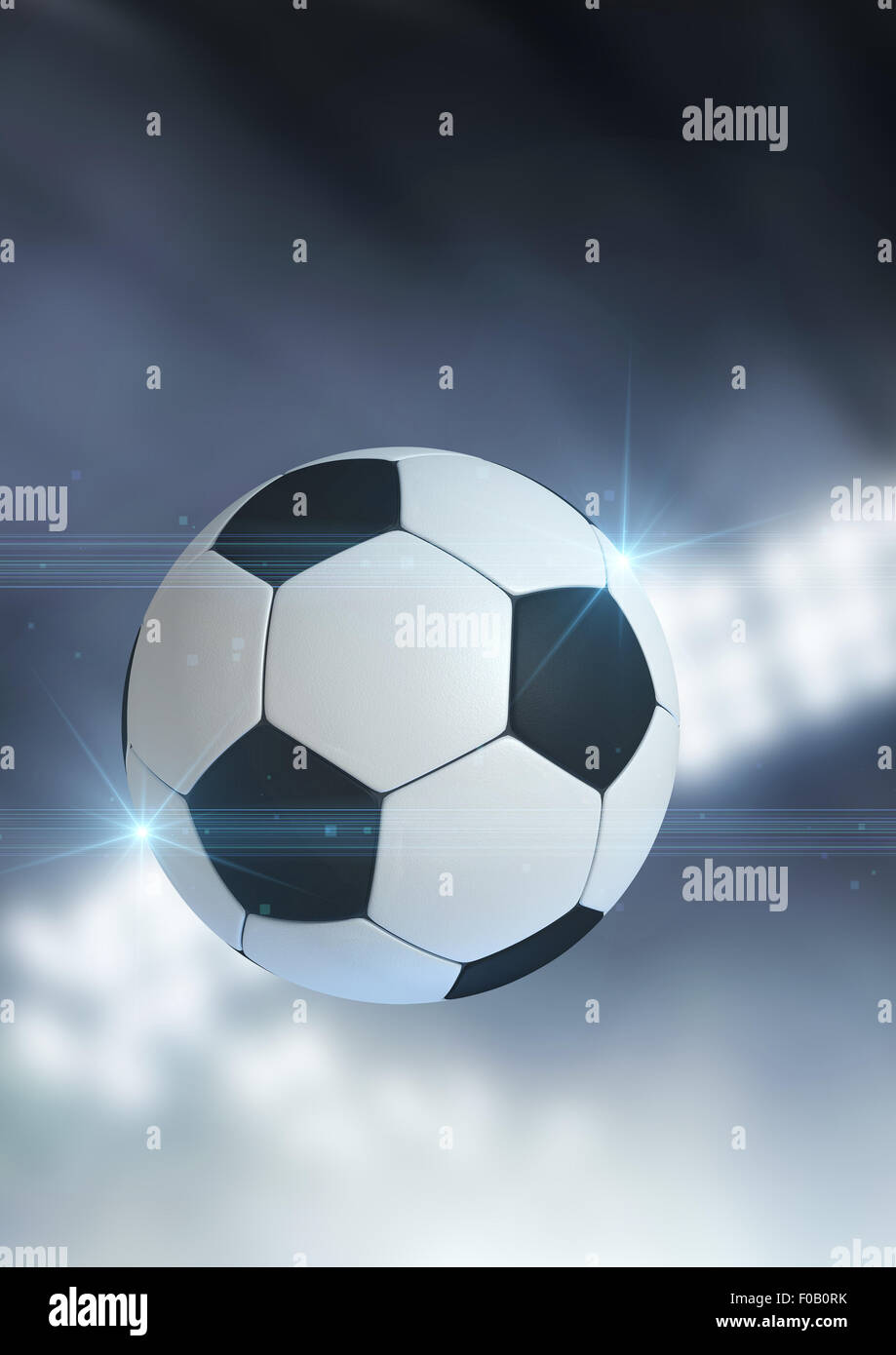 A regular soccer ball flying through the air on an indoor stadium ...