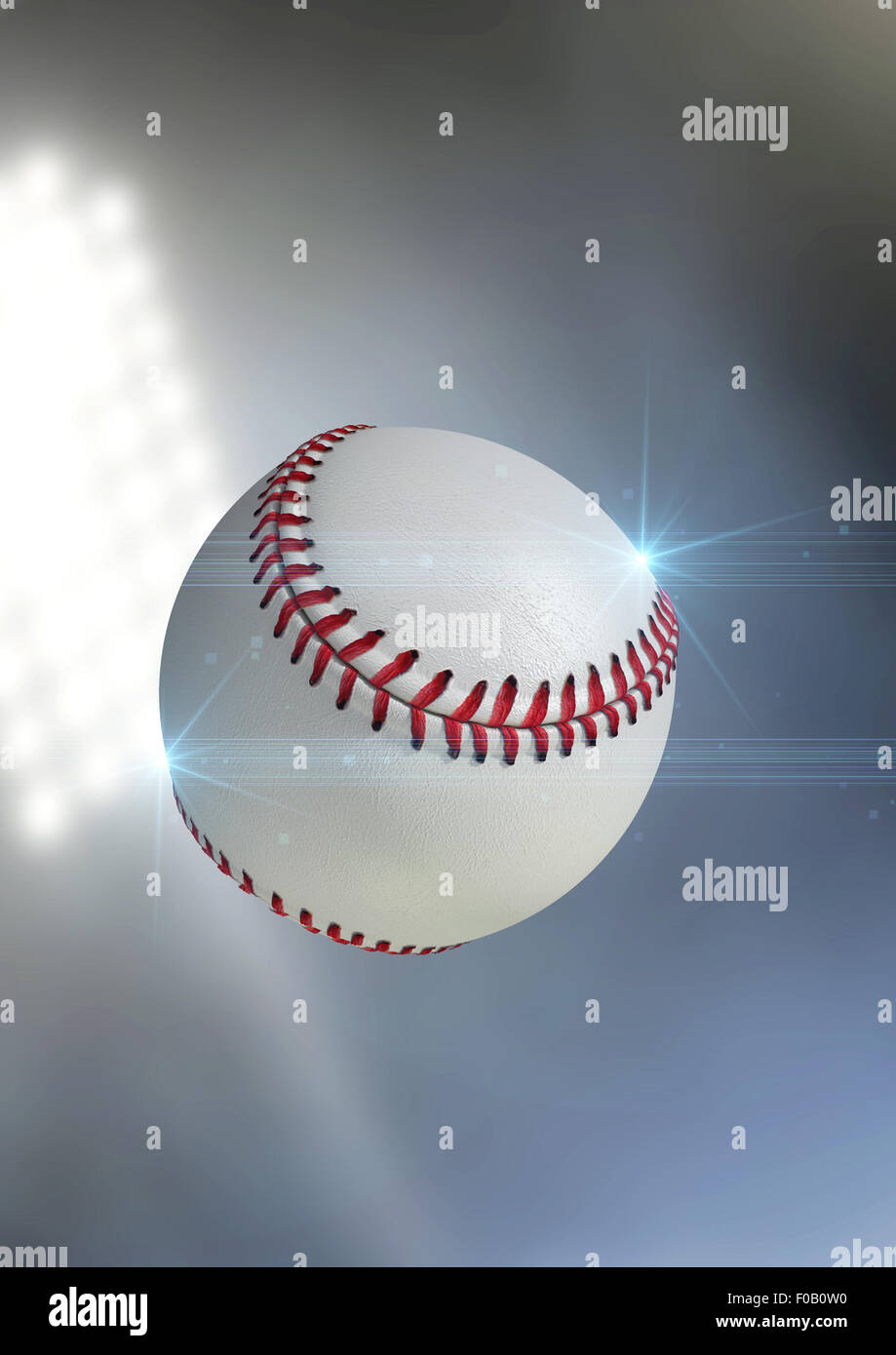 A regular baseball ball flying through the air on an a outdoor stadium ...